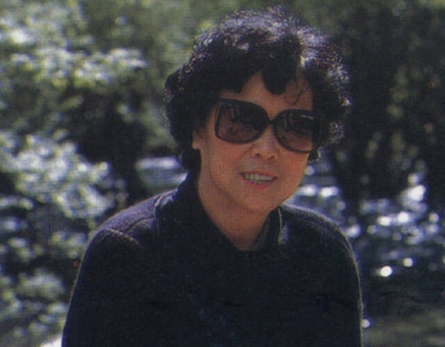 At the memorial service, the crowd held flowers, and all the leading ...