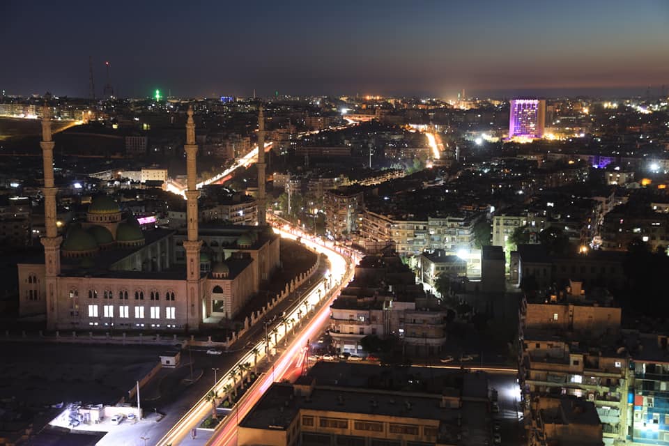 Overlooking Aleppo, Syria, the night lights are dazzling, and the look ...