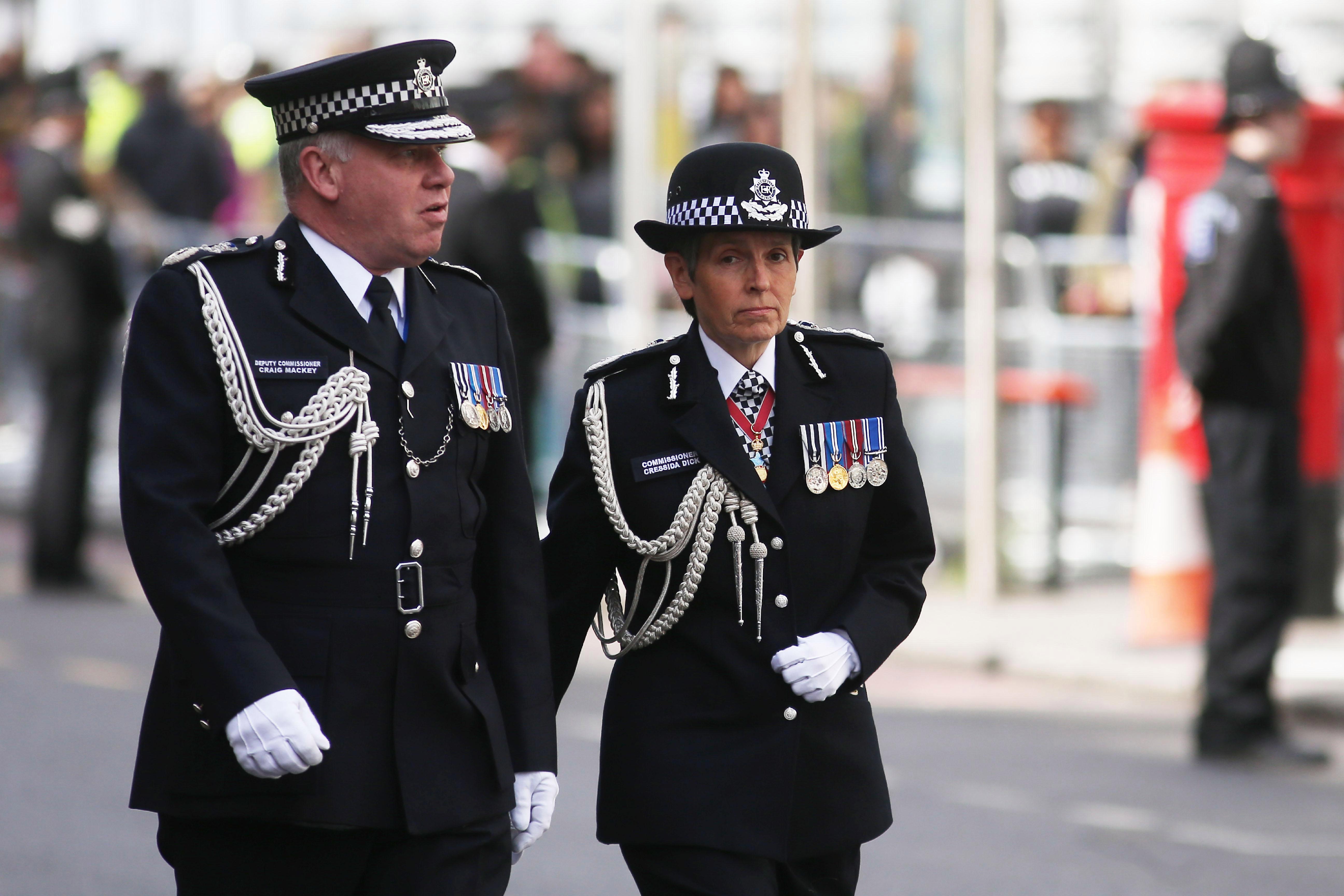 British police uniforms, wearing bulletproof vests over the shirts, and ...