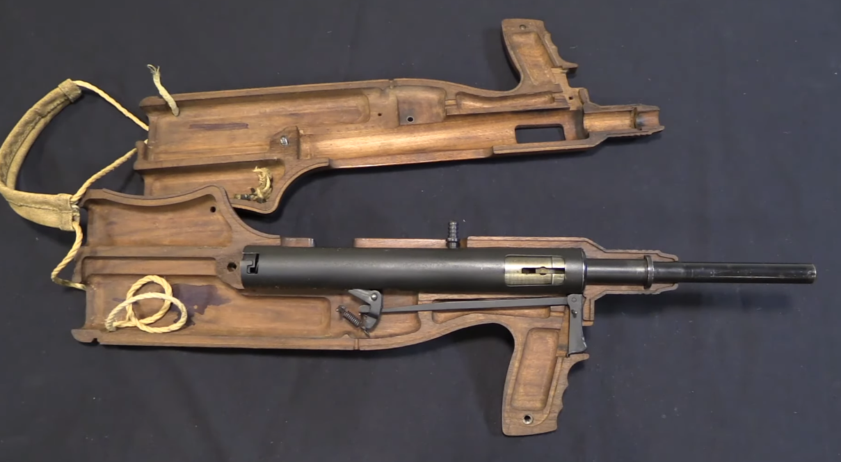 A close relative of the Stern submachine gun, the British one-handed ...