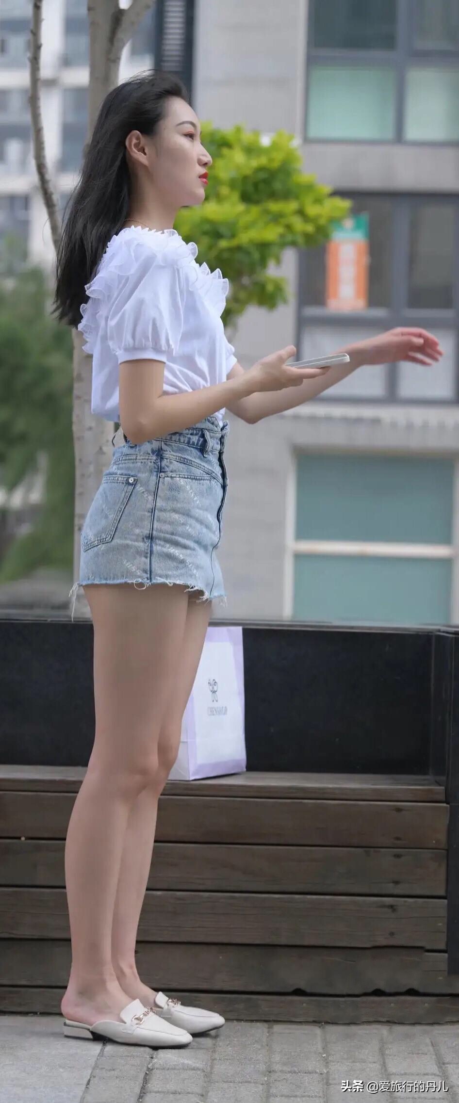 White big round neck shirt with blue denim skirt pants, exuding an ...