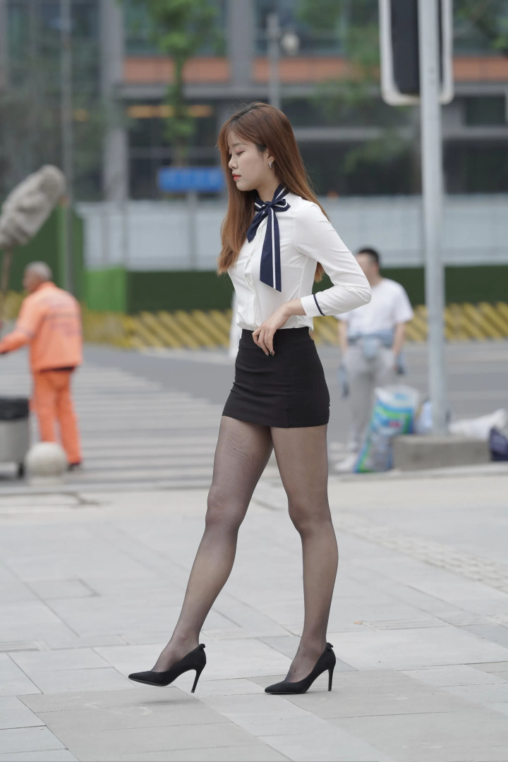 The young lady in professional attire with black high heels has a sweet ...