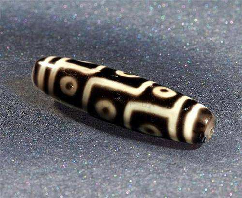 There are only two nine-eyed dzi beads in the world, one of which is ...