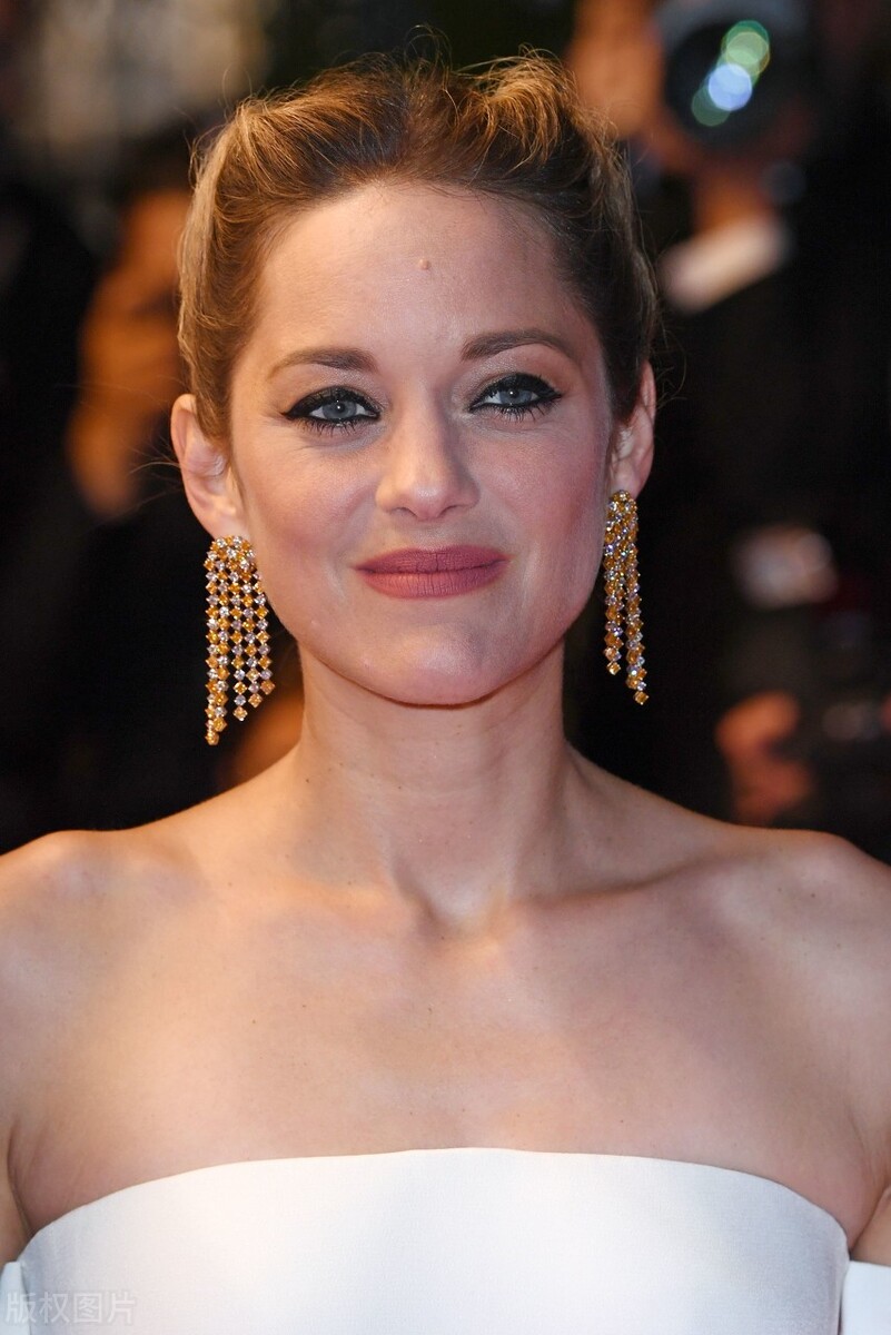 Marion Cotillard: wearing a white tube top jumpsuit, elegantly tanned ...